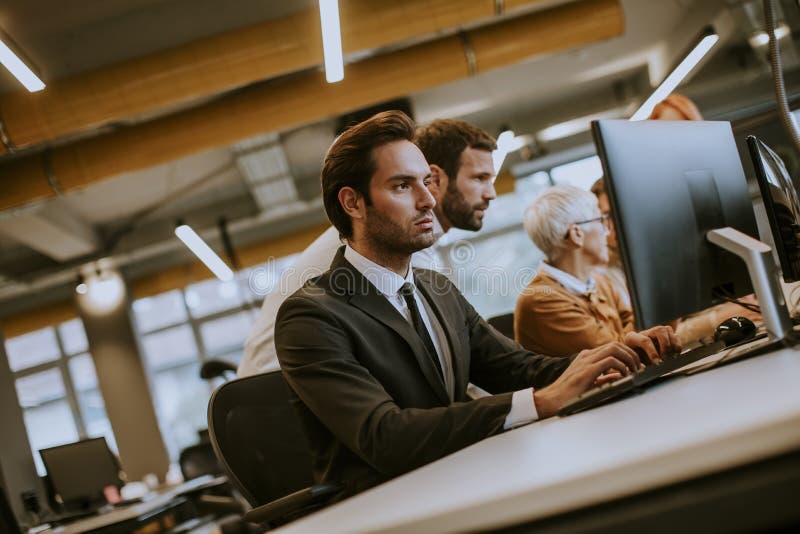 Young Professional Businessman Uses a Laptop for Work in the Office ...