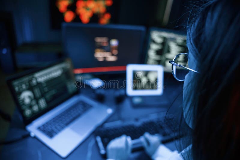 Young Professional Female Hacker is Indoors by Computer with Lot of ...