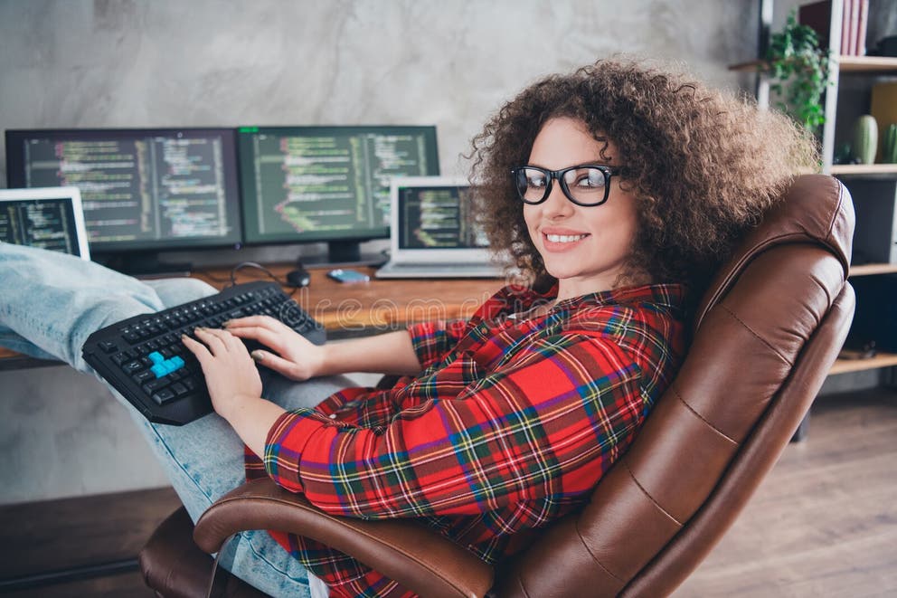 Young Professional Female Programmer Working Remotely in a Modern Home Office Setup, Coding and ...