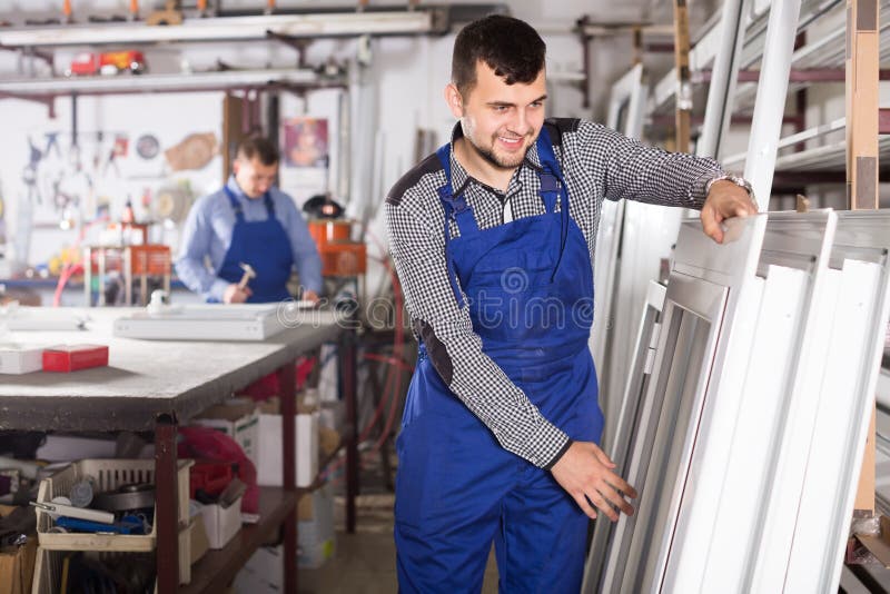 Young Professional Labours with Finished PVC Profiles and Window Stock ...