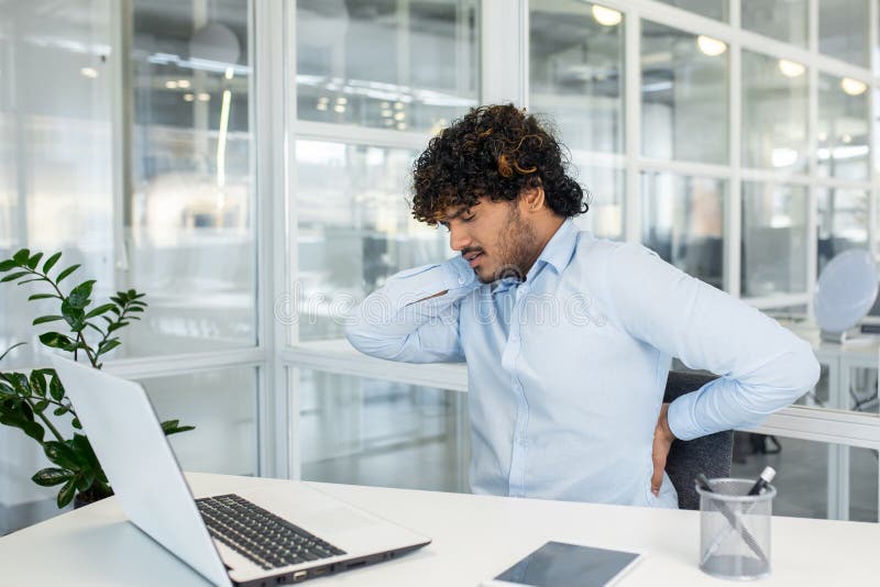 Young Man Experiencing Back Pain while Working at His Office Desk Stock ...