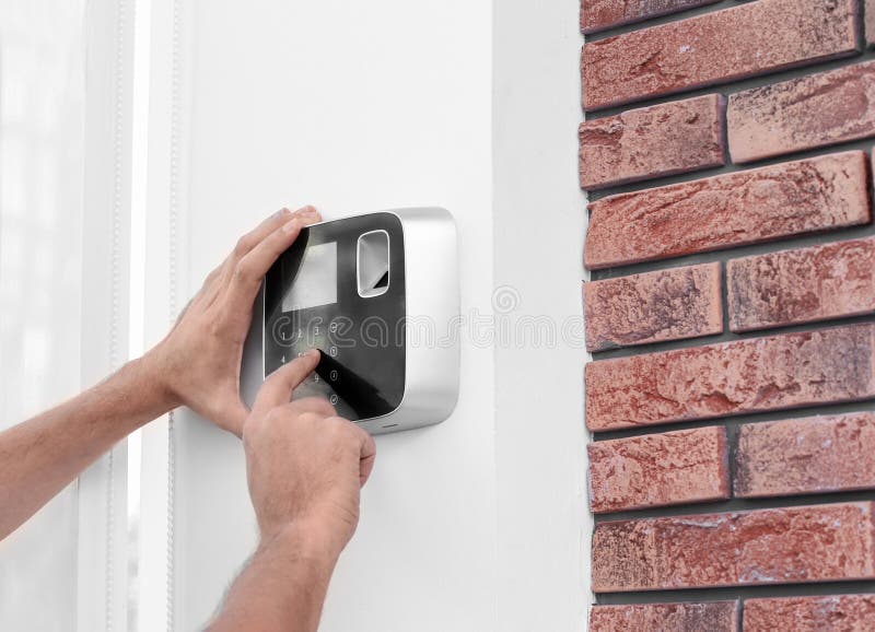 Young Male Technician Programming Alarm System Indoors Stock Image ...