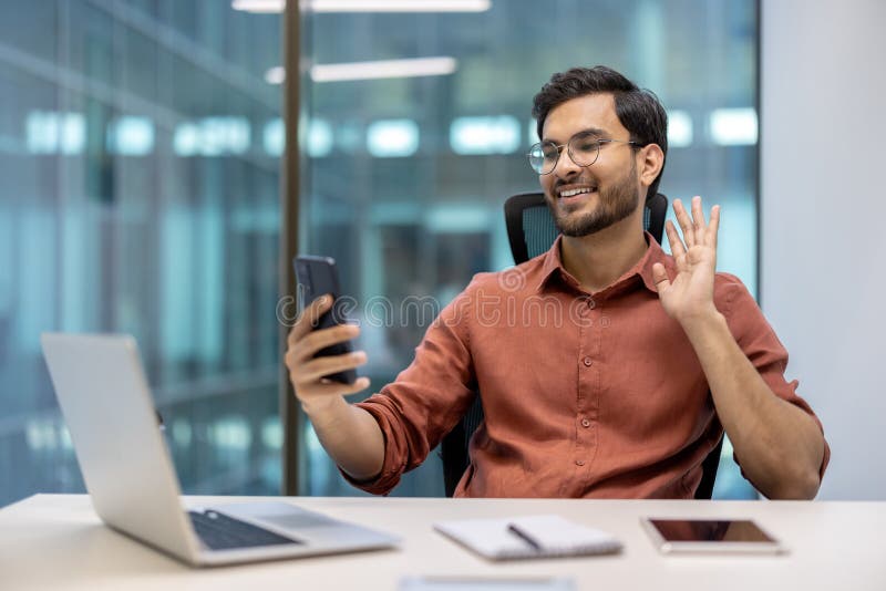 Young Professional in Office Happily Engaging in Video Call on ...