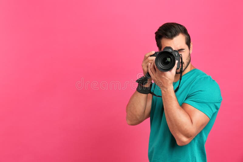 Young Professional Photographer Taking on Pink Background. Space for ...