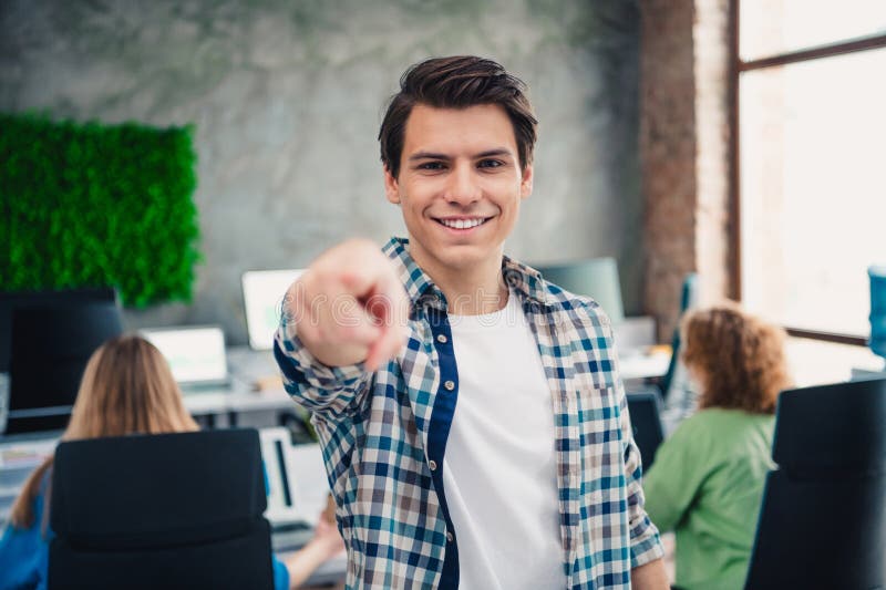 Young Professional Pointing Confidently at the Camera in a Modern ...