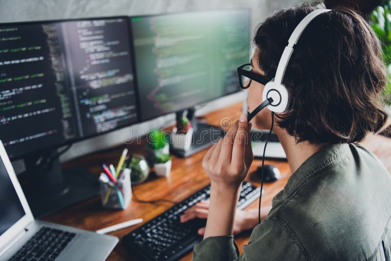 Young Programmer Working on Coding Projects in Home Workspace Using Dual Monitors and Headphones ...
