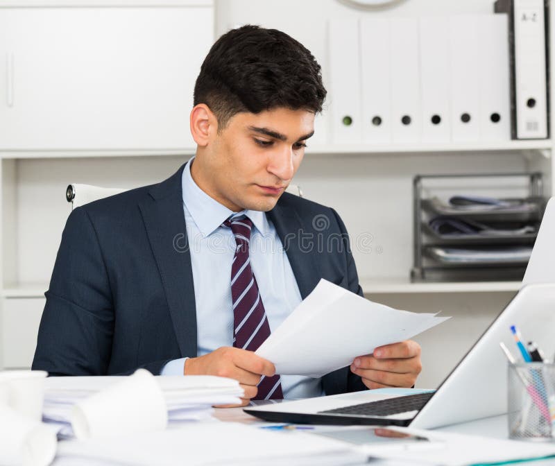 Young Professional is Reading Documents about the Transaction Stock ...