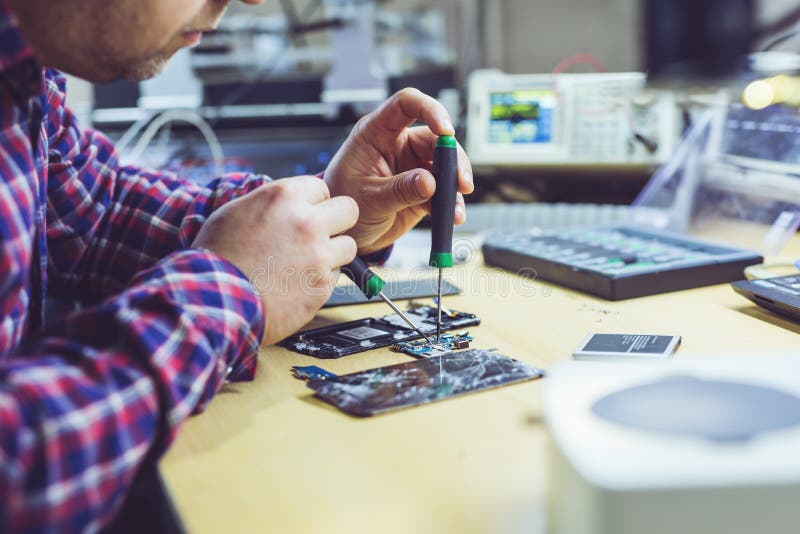 Professional Repairman Repairing Computer in Workshop. Stock Photo ...