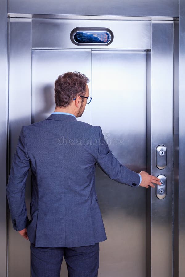 Young Professional in Suit Waiting in Front of the Elevator Stock Photo ...