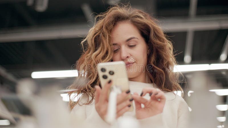 Customer Comparing Smartphone Models in Electronics Store Slow Motion ...