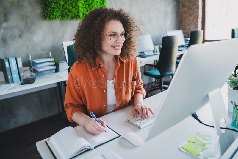 Young Professional Woman Working in a Modern Office Setting, Typing on ...