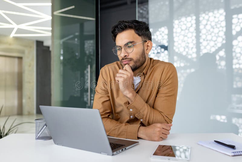 Young Professional Working on a Laptop in a Modern Office Stock Image ...
