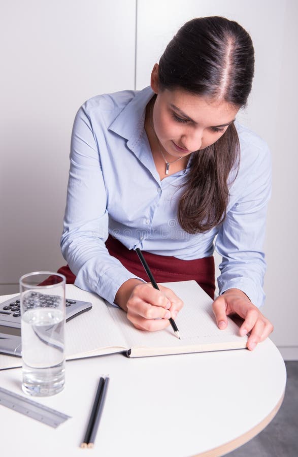 Young Professional is Writing Her Idea in Open Notebook Stock Image ...