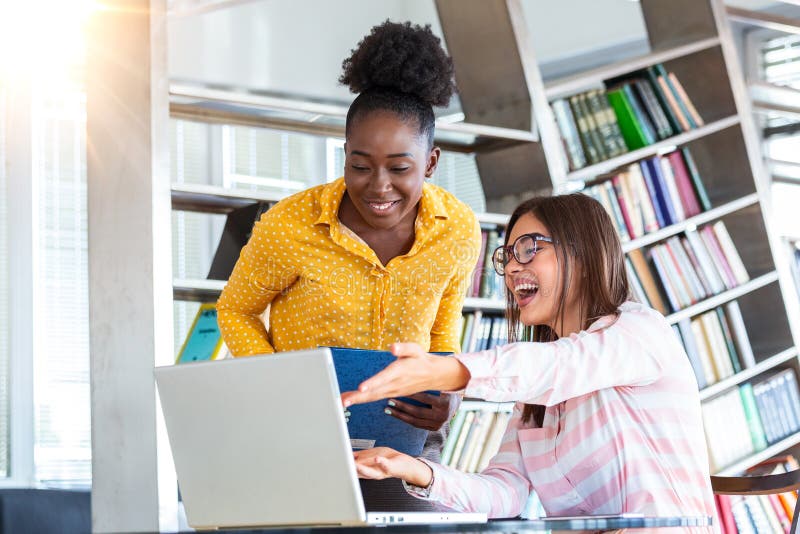 Young Professionals Work in Company, Using Laptop and Tablet. Two Women ...