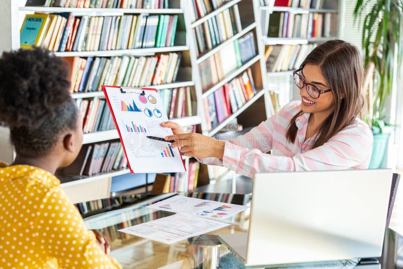 Young Professionals Work in Company, Using Laptop and Tablet. Two Women ...