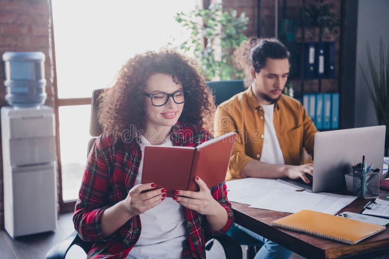 Young Professionals Working and Reading in a Modern Office with Casual ...