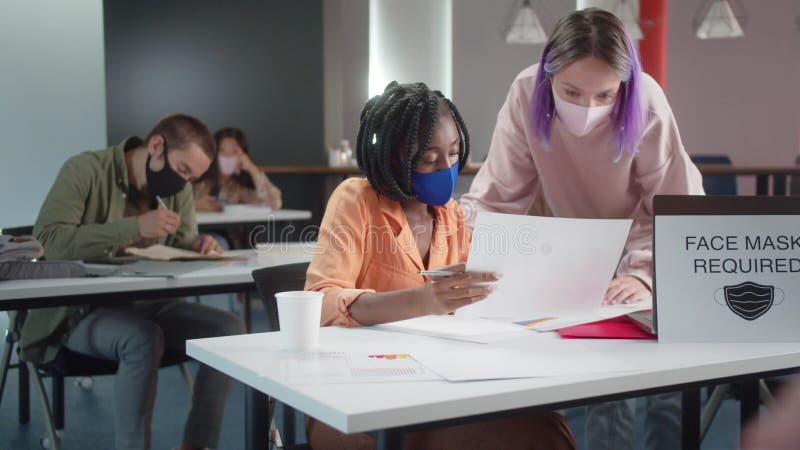The Young Professor is Checking the Homework of Her Student and a ...