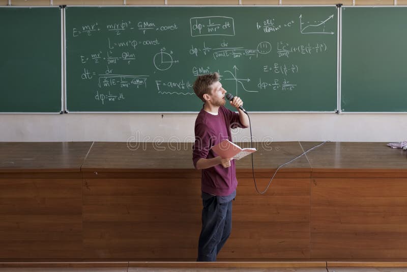Young Professor Teacher Speaking with the Microphone in the Lecture ... Young Professor Teacher Speaking with the Microphone in the Lecture ...
