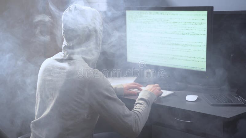 Young Programmer Working on a Computer and Smoke on Background ...