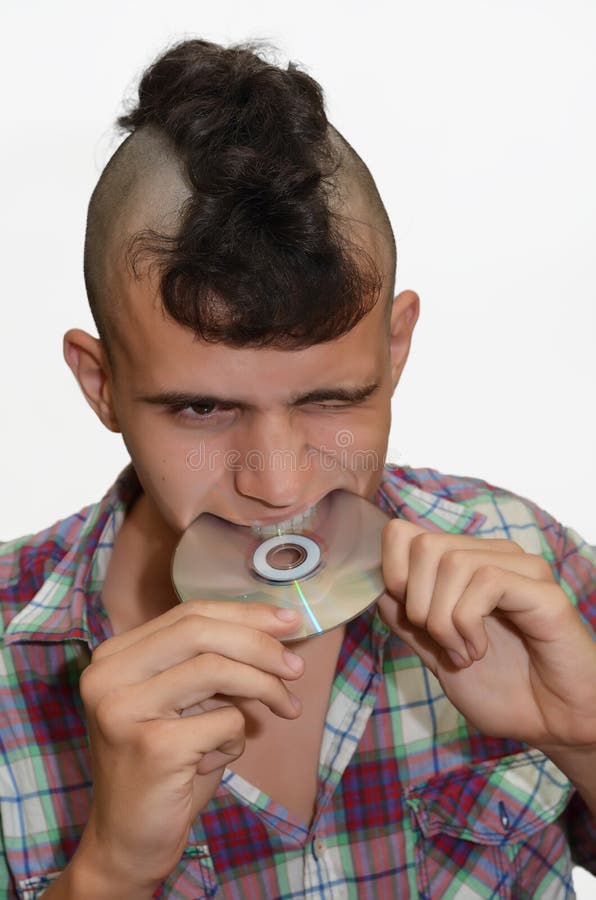 Young punk bites CD. stock photo. Image of people, music - 33628250