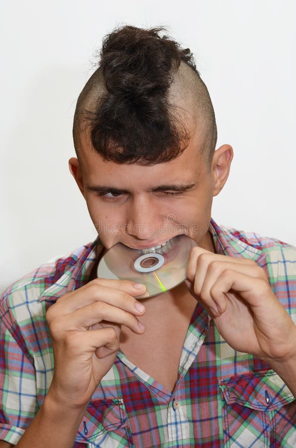Young punk bites CD. stock photo. Image of real, music - 33628256