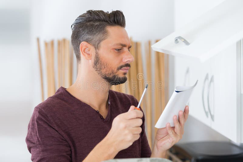 Man Reading Assembly Instructions for Flat Pack Stock Image - Image of ...
