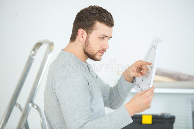 Man Reading Assembly Instructions for Flat Pack Stock Image - Image of ...