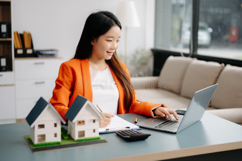 Young Real Estate Agent Worker Working with Laptop and Tablet at Table ...