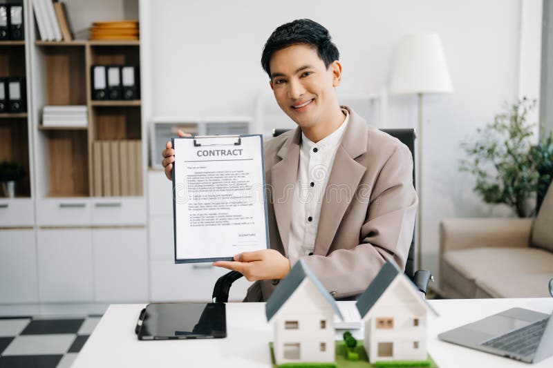 Young Real Estate Agent Worker Working with Laptop and Tablet at Table ...