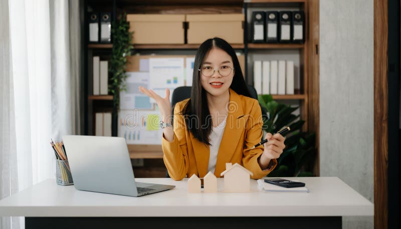 Young Real Estate Agent Worker Working with Laptop and Tablet at Table ...