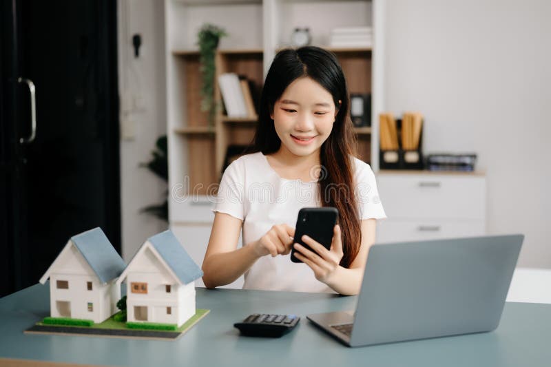 Young Real Estate Agent Worker Working with Laptop and Tablet at Table ...
