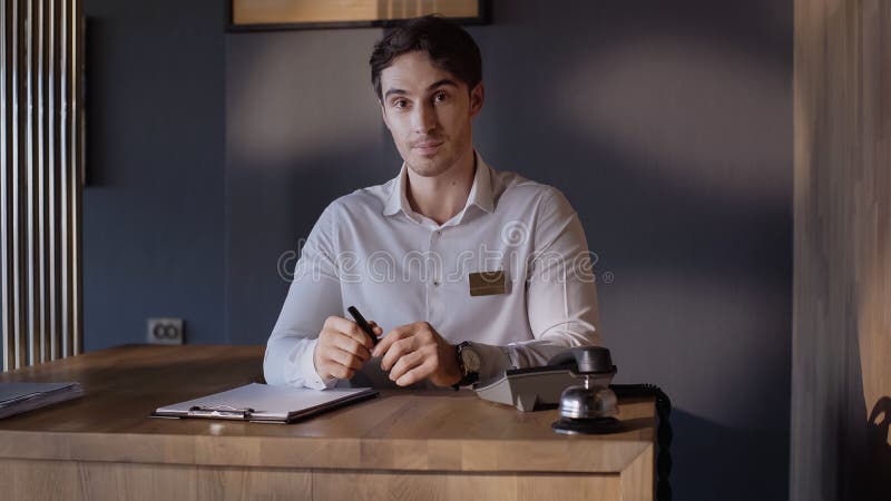 Handsome Receptionist Standing at Reception Desk Stock Photo - Image of ...