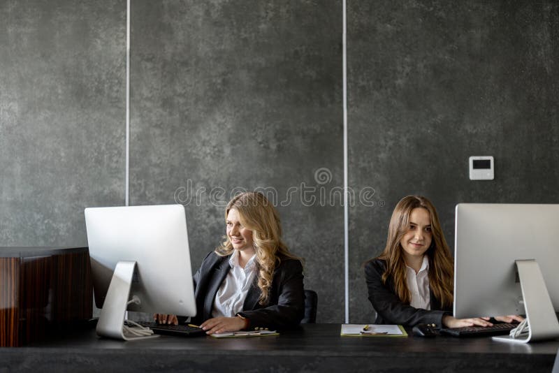 Young Receptionists at the Reception Desk Stock Image - Image of ...