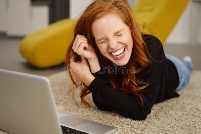 Young Laughing Woman Lying in Front of Laptop Stock Photo - Image of ...