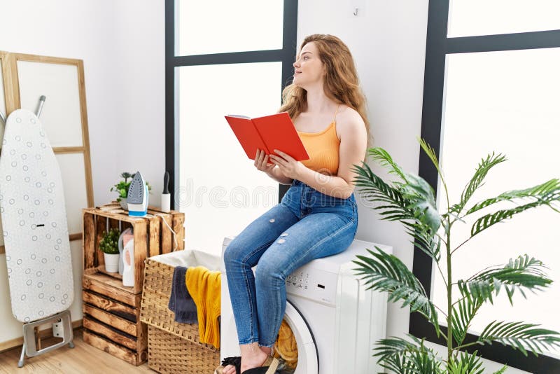 Young Redhead Girl Washing Clothes Reading Book at Laundry Stock Photo ...
