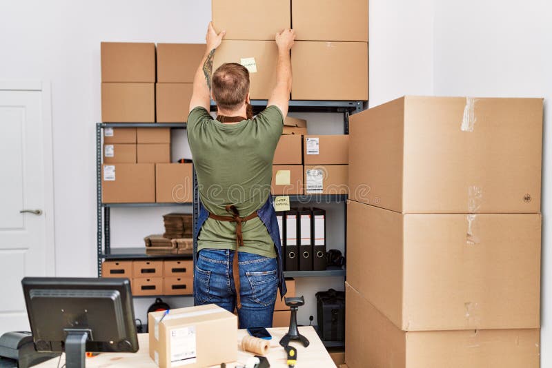 Young Redhead Man Business Worker on Back View Organizing Packages at ...