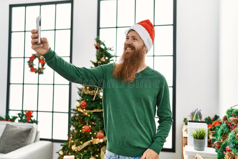 Young Redhead Man Make Selfie by the Smartphone Standing by Christmas ...