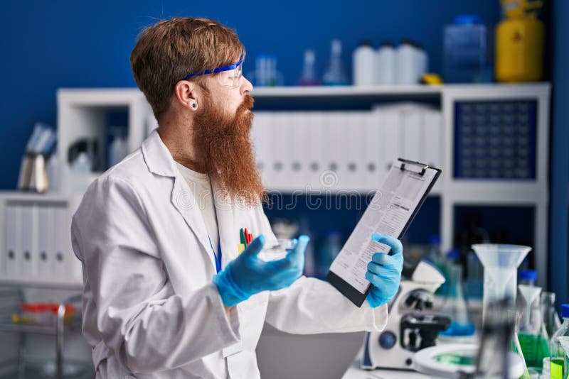 Young Redhead Man Scientist Reading Report Holding Sample at Laboratory ...
