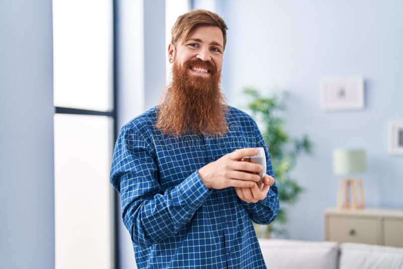 Young Redhead Man Smiling Confident Drinking Tea at Home Stock Photo ...