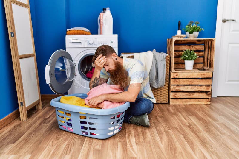 Young Redhead Man Stressed Washing Clothes at Laundry Room Stock Image ...