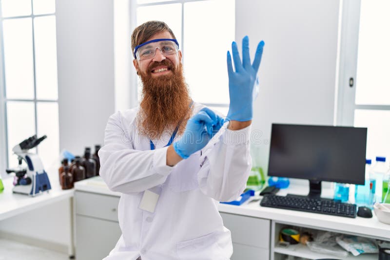 Young Redhead Man Wearing Scientist Uniform Wearing Gloves at ...