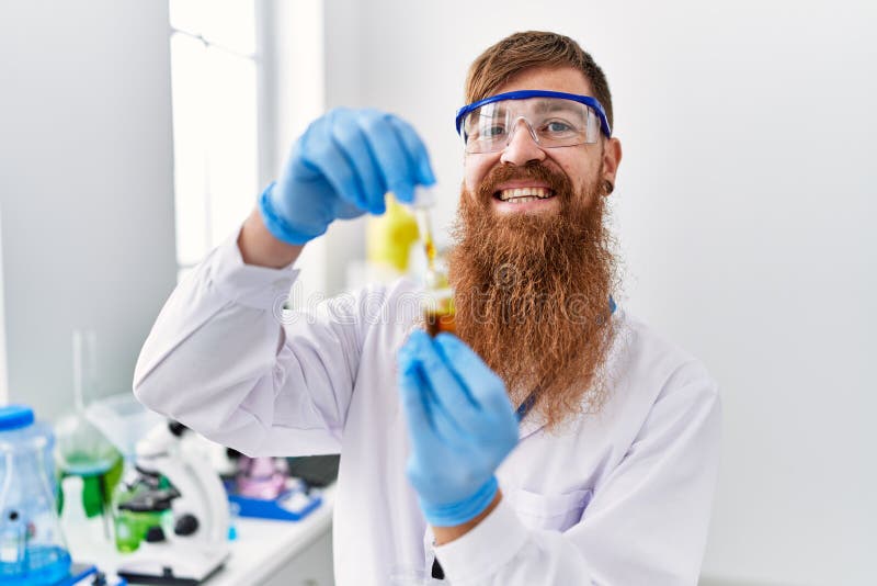 Young Redhead Man Wearing Scientist Uniform Holding Reactive at ...