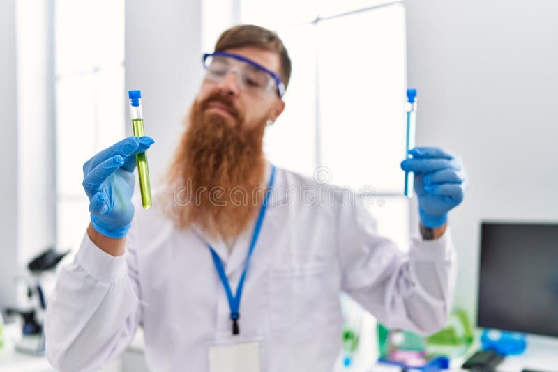 Young Redhead Man Wearing Scientist Uniform Holding Test Tubes at ...