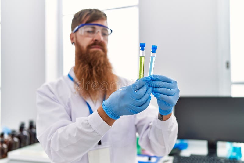 Young Redhead Man Wearing Scientist Uniform Holding Test Tubes at ...