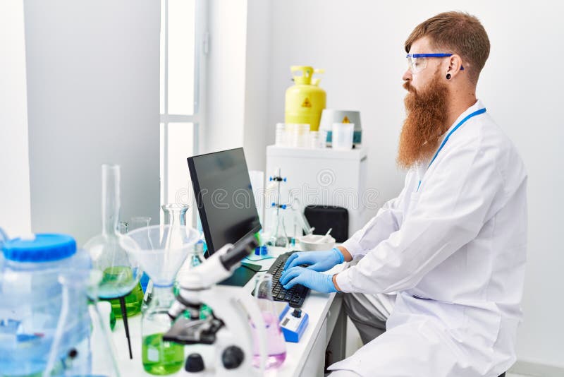 Young Redhead Man Wearing Scientist Uniform Working at Laboratory Stock ...