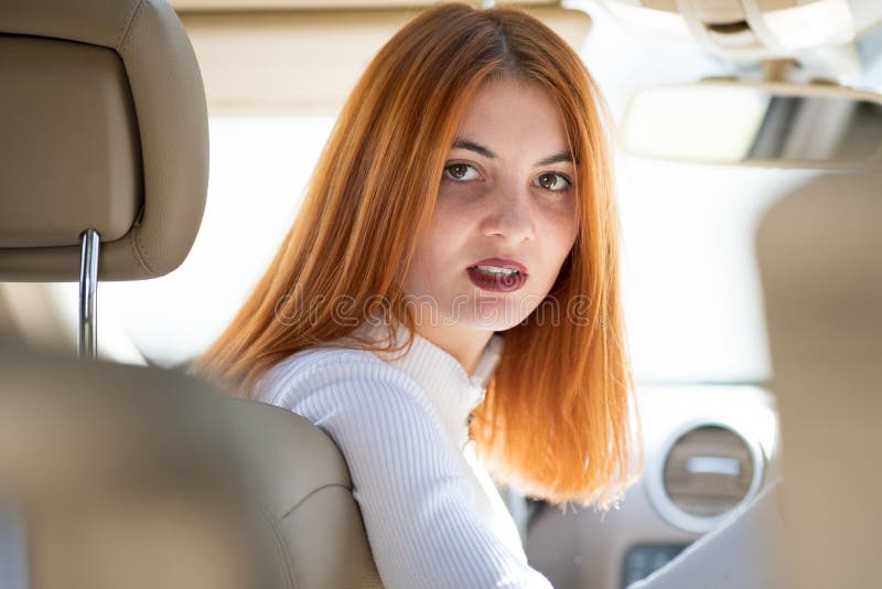 Young Redhead Woman Driver Driving a Car Backwards Stock Image - Image ...