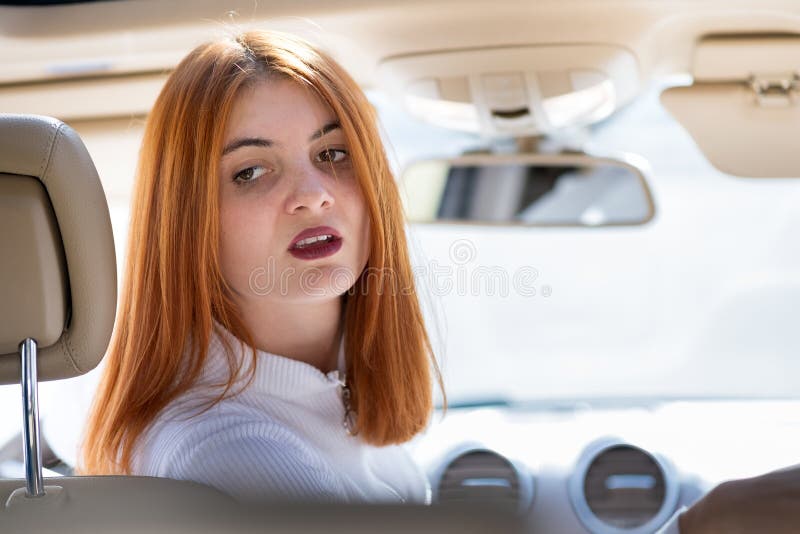 Young Redhead Woman Driver Driving a Car Backwards Stock Photo - Image ...