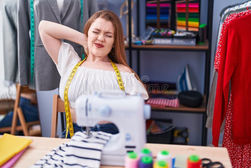 Young Redhead Woman Tailor Stressed Using Sewing Machine at Clothing ...