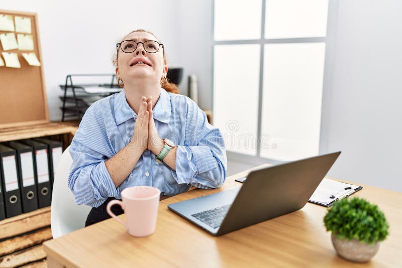 Young Redhead Woman Working at the Office Using Computer Laptop Begging ...