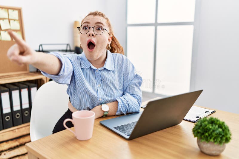 Young Redhead Woman Working at the Office Using Computer Laptop ...